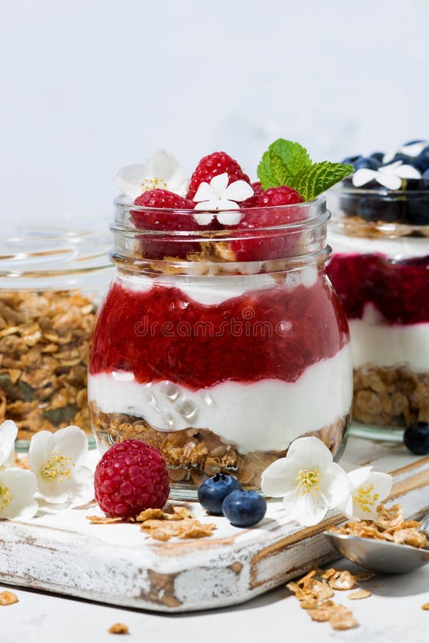 Desserts with Muesli, Berry and Fruit Puree in Jars on White Table ...