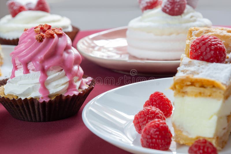 Desserts with Raspberries on White Plates on the Table Stock Photo ...