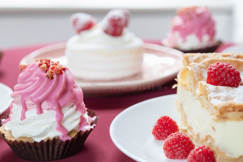 Desserts with Raspberries on White Plates on the Table Stock Image ...