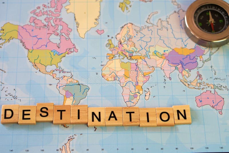 Destination Concept. Wooden Letters on a Map of the World and a Compass ...