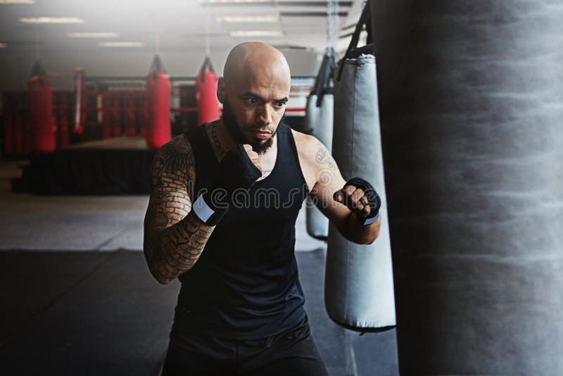 Destroy What Destroys You. a Kick-boxer Training in a Gym. Stock Image ...