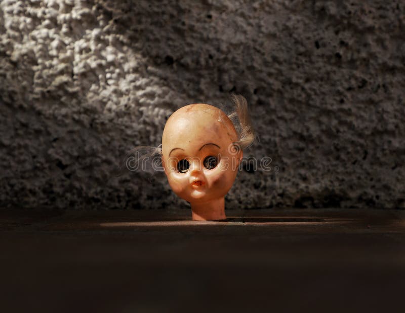 A Destroyed and Disturbing Broken Doll with Head Stock Photo - Image of ...