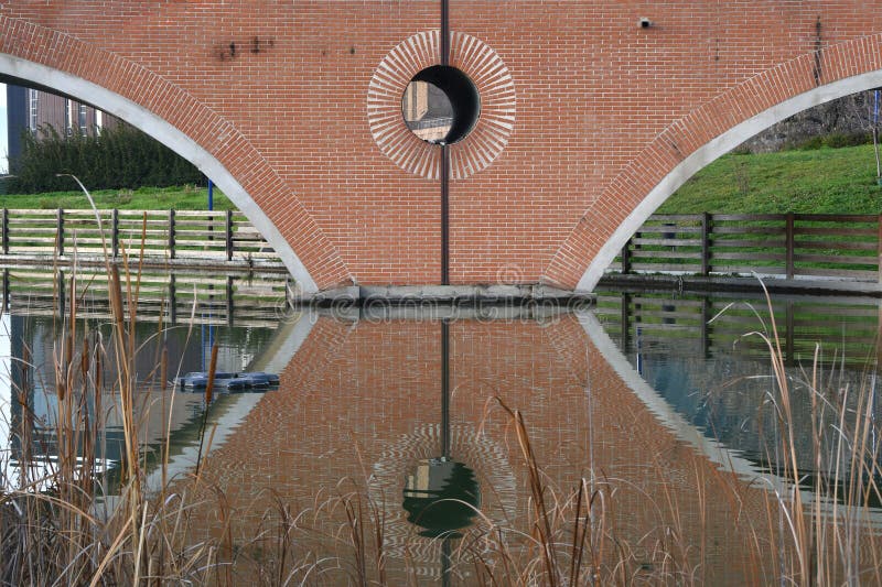 Detail of a Brick Bridge Reflected in a Pond in a Public Park Stock ...