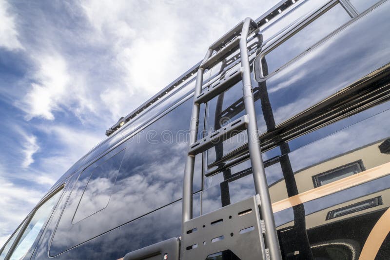 Camper Van with a Ladder, Roof Racks and Recovery Ladders Stock Image ...