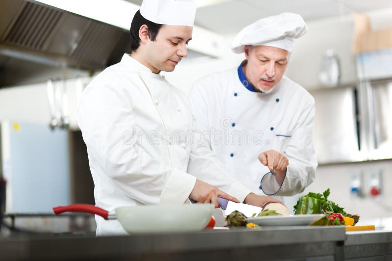Head Chef and Waiter Discussing Menu Stock Image - Image of kitchen ...