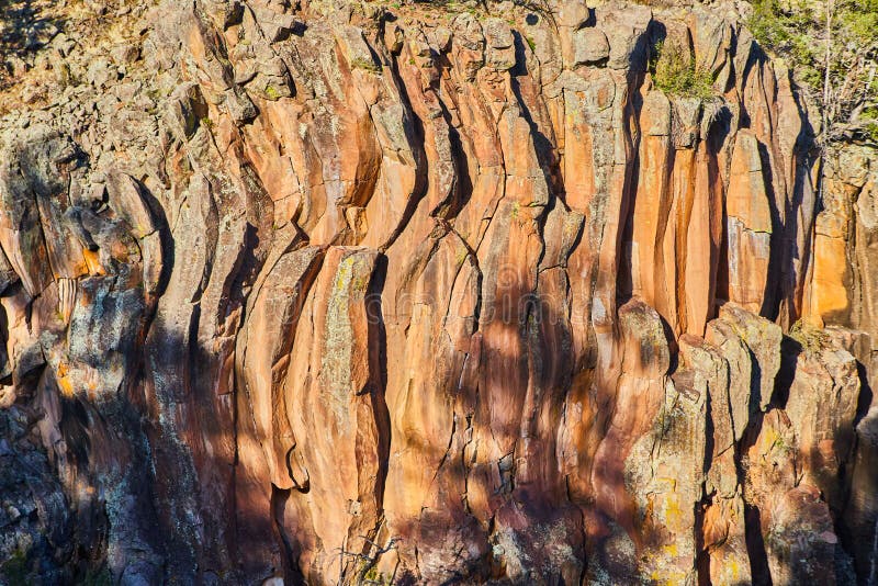 Detail of Cliff with Wavy Vertical Rock Formations in Golden Light ...