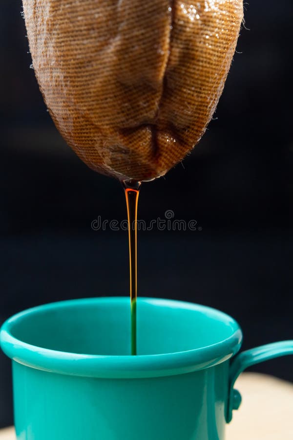 Coffee Being Filtered through a Cloth Strainer. Stock Image - Image of ...