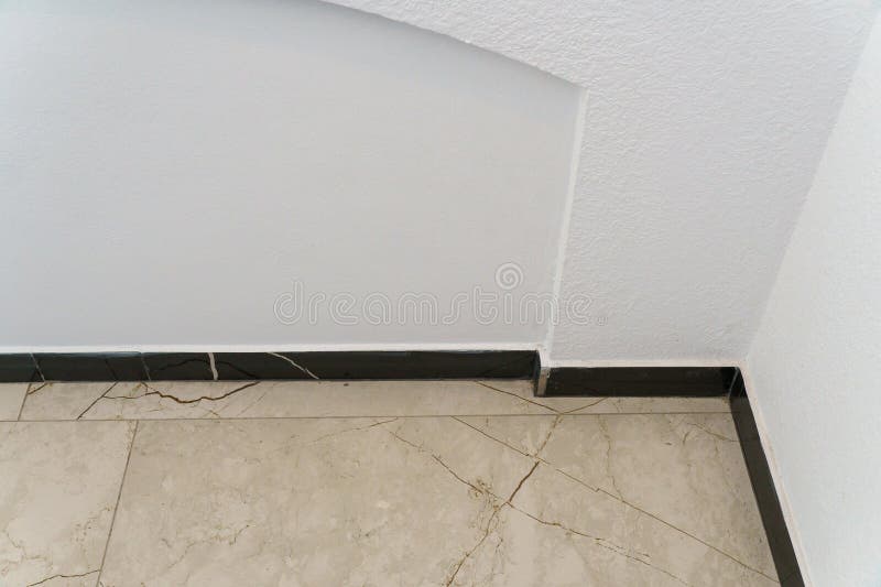 The Detail of the Corner Baseboard on the Wall and Granite Tiles on the ...