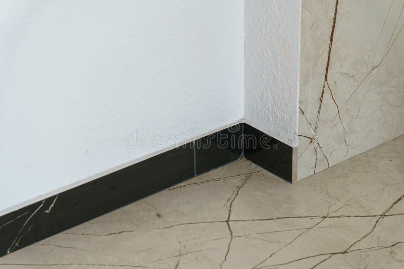 The Detail of the Corner Baseboard on the Wall and Granite Tiles on the ...