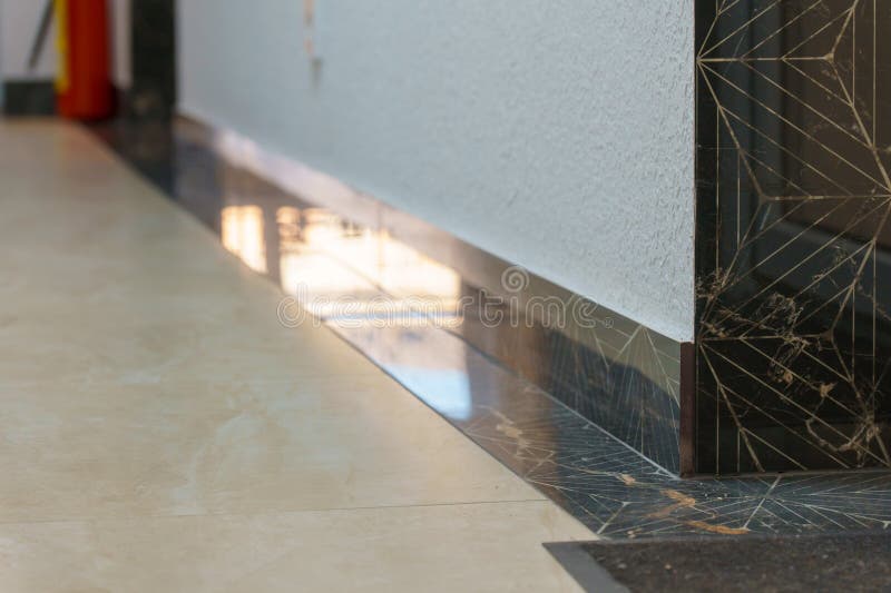The Detail of the Corner Baseboard on the Wall and Granite Tiles on the ...