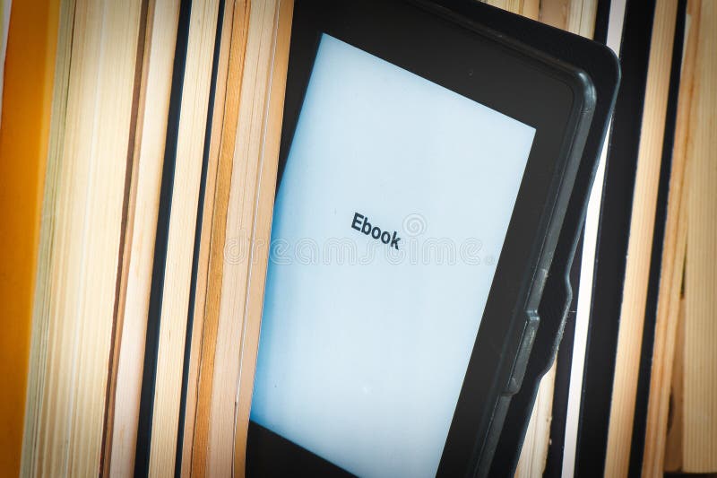 Detail of an E-book Reader among Classic Books Stock Photo - Image of ...