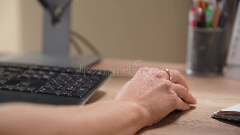 Detail on a Hand Controlling a Computer Using a Keyboard and a Mouse ...