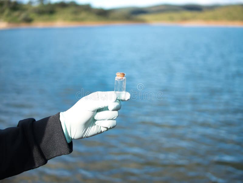 Detail of a Hand Holding a Jar with a Contaminated Water Sample for ...
