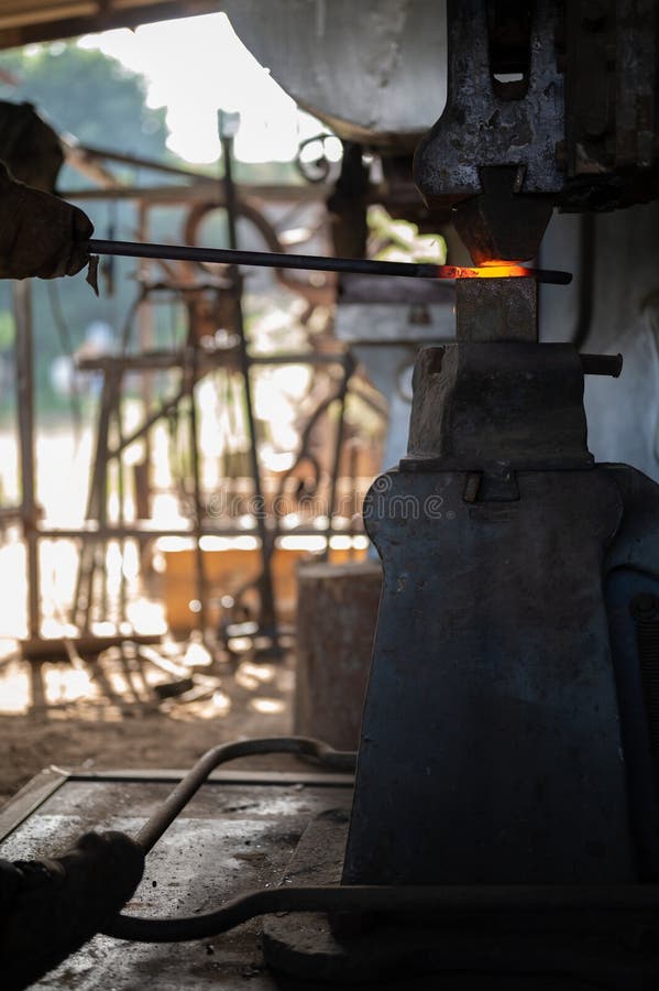 Detail of a Mechanical Hammer Working a Piece of Metal in a Forge ...