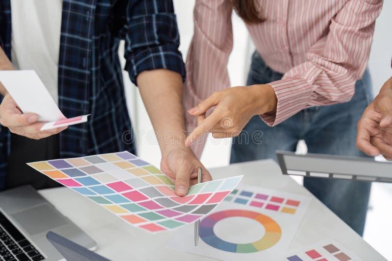 Detail Orientation and Team Dynamics. Colleagues Analyzing Color Charts ...