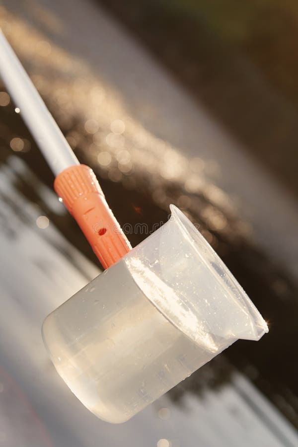 Detail of Plastic Sampling Beaker on Rod with Sample of Water Stock ...
