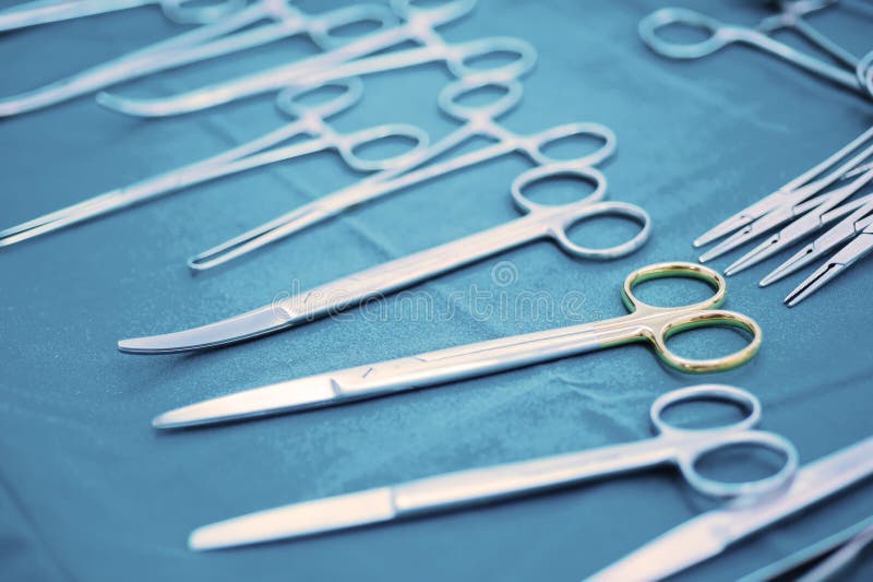 Detail Shot of Steralized Surgery Instruments with a Hand Grabbing a ...