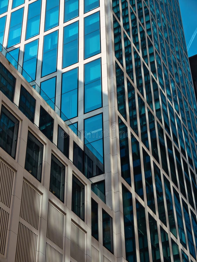 A Detail of a Skyscraper with White Front and Large Glass Windows with ...