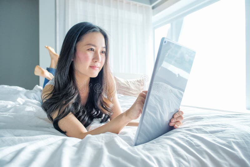Young Woman Using Tablet on the Bed Stock Image - Image of detail, cell ...