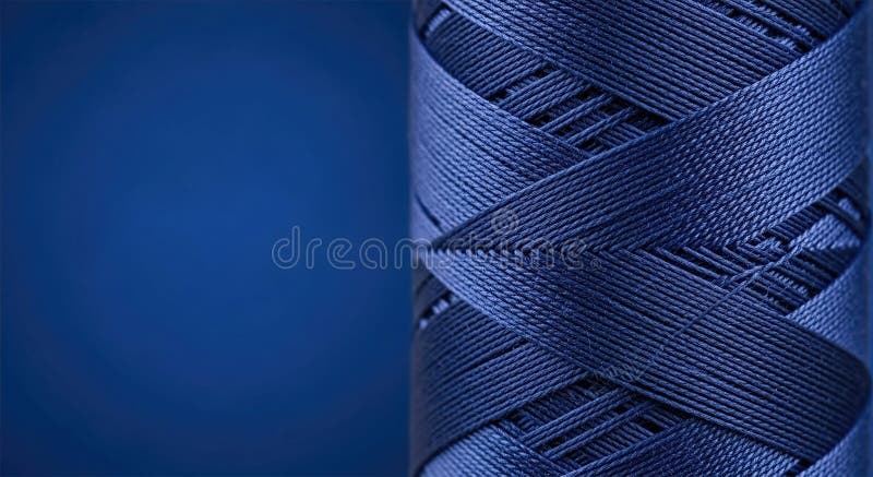 A Detailed Close-up of a Blue Sewing Thread Wound Crosswise on a Spool ...