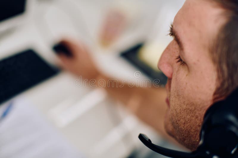 Close Up Portrait of a Customer Support Representative in a Call Center ...