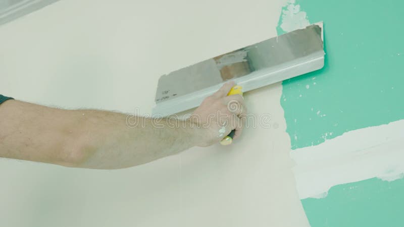 Close Up of Hand Applying Putty on Wall with Trowel during Renovation ...