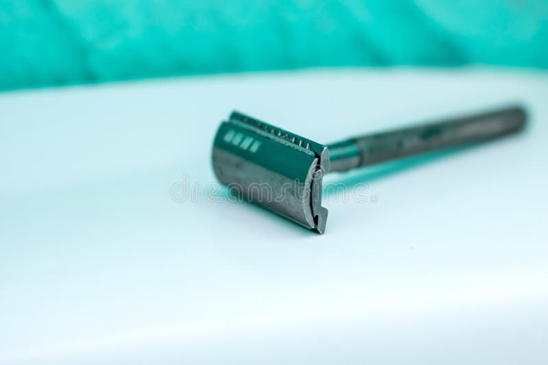 A Detailed Close Up Image of a Razor Resting on a Plain White Surface ...