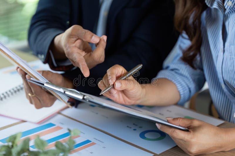 Detailed Financial Discussion. Professionals Engaging Over Charts and ...