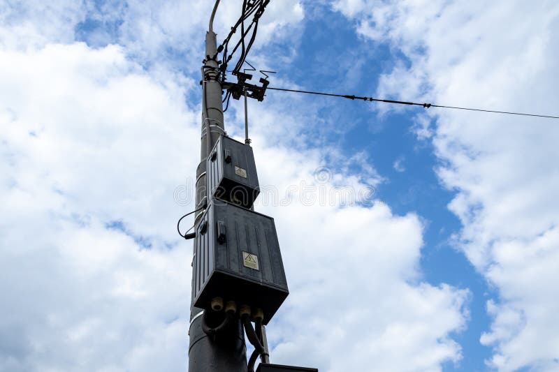 Towering Utility Pole Supporting Multiple Electrical Boxes and Complex ...