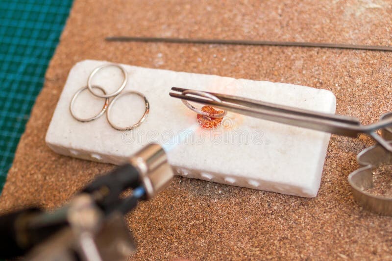 Detailed Process of Jewelry Making with a Torch on a White Work Surface ...