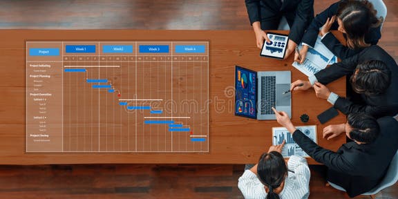 Detailed Project Management Meeting with Team Analyzing Gantt Chart and ...
