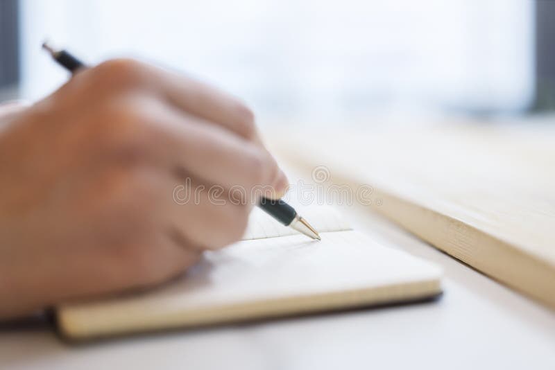 Detailed View of a Man S Hand Jotting Notes in a Notepad Stock Photo ...