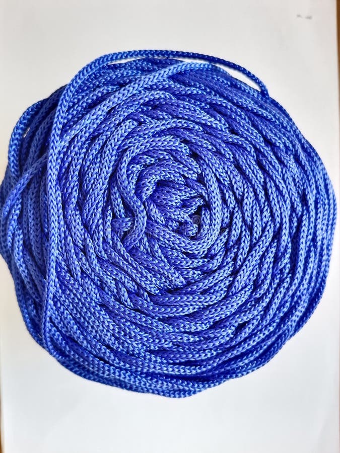 Close-Up of Rolled Blue Rope in a Spiral Pattern on White Background ...