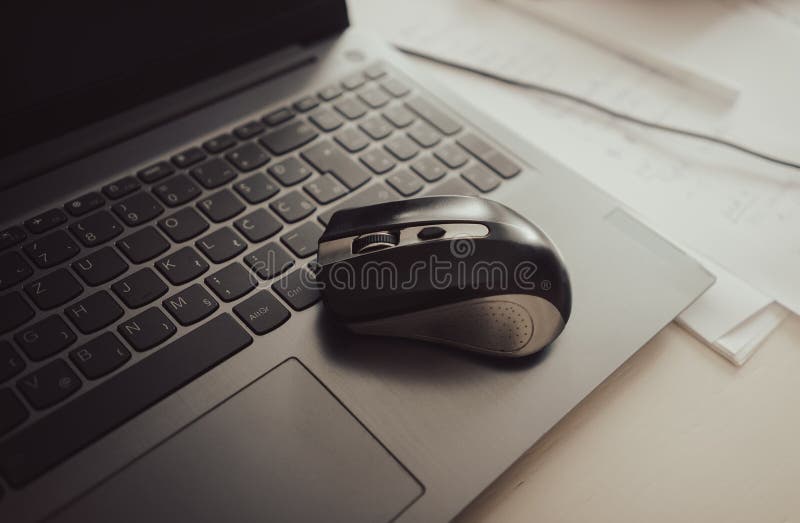 Computer Mouse on an Open Laptop on a White Table Stock Photo - Image ...