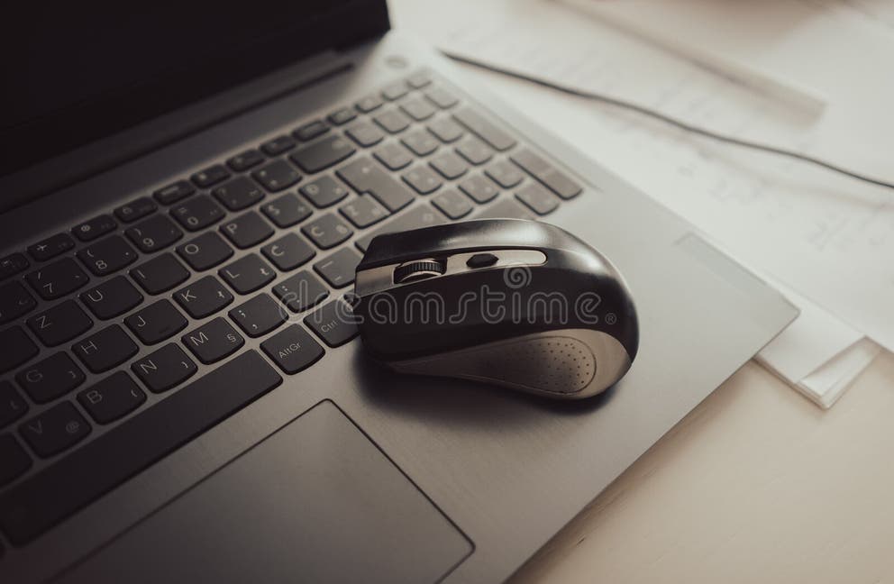 Computer Mouse on an Open Laptop on a White Table Stock Photo - Image ...