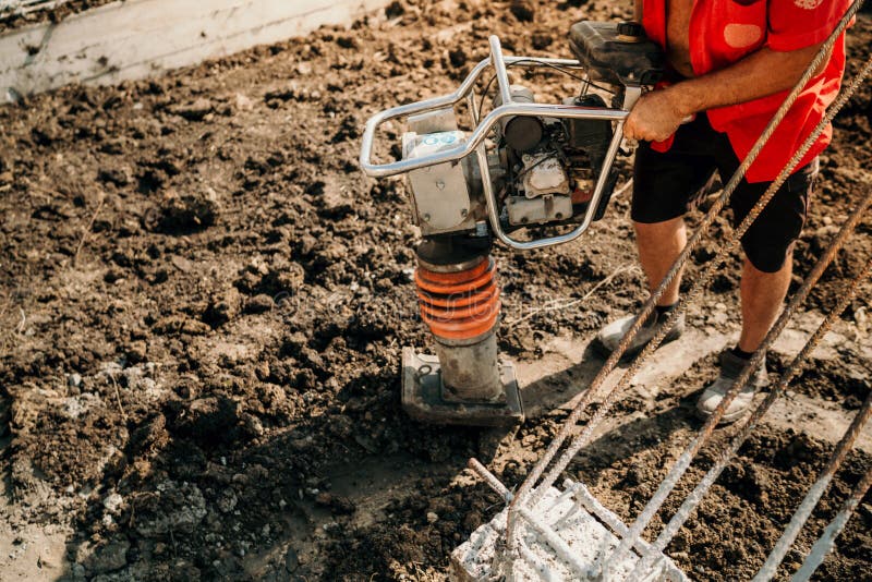 Construction Worker Using Compactor for Earth and Soil Compacting Stock ...
