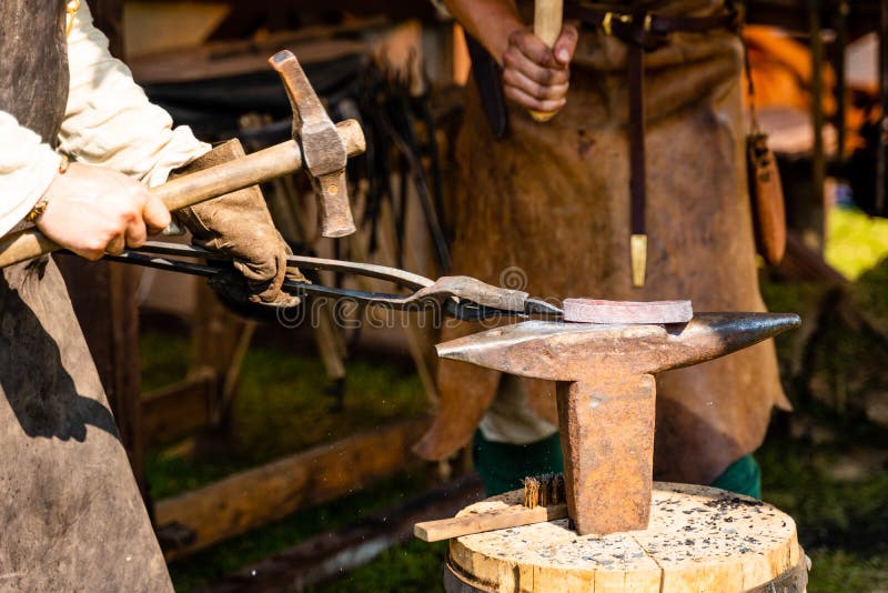 Blacksmith Forges Metal, Holds the Workpiece with Ticks and Hits with a ...