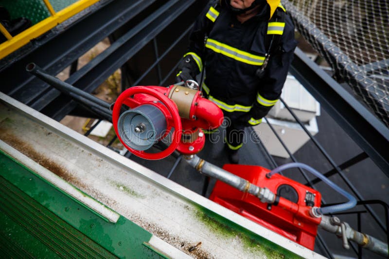 Details with the Hands of a Firefighter Holding a Fire Suppression ...