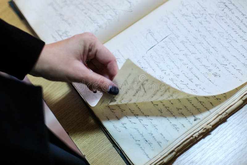 Details with the Hands of a Young Woman Reading an Archive Document ...