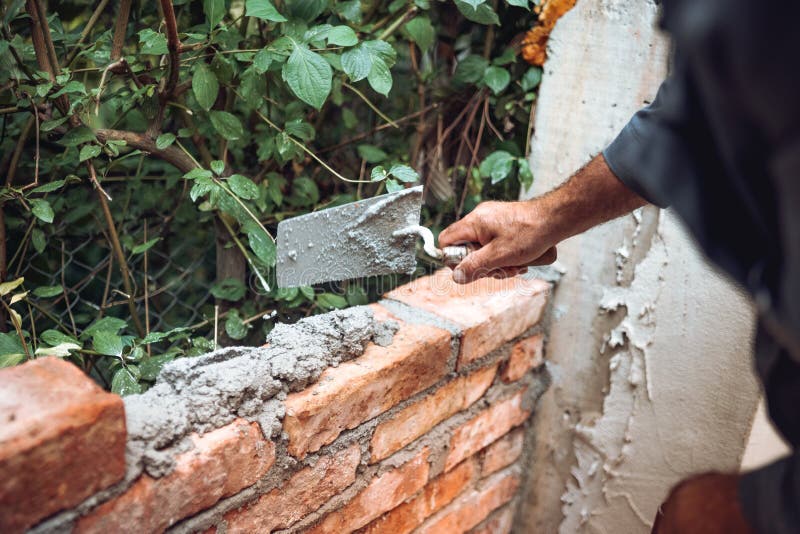 Details of Worker, Bricklayer Placing and Adjusting Bricks with Mortar ...