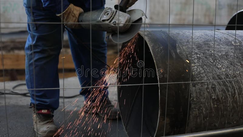Details with a Worker Using an Angle Grinder on an Industrial Metallic ...