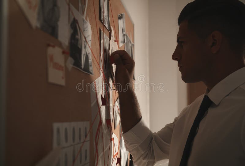 Detective Looking at Evidence Board in Office, Closeup Stock Image ...