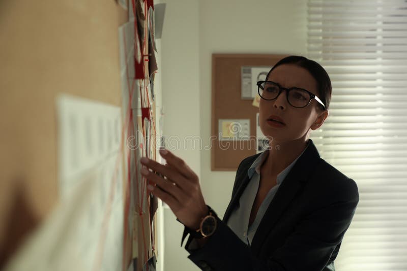 Detective Looking at Evidence Board in Office Stock Image - Image of ...