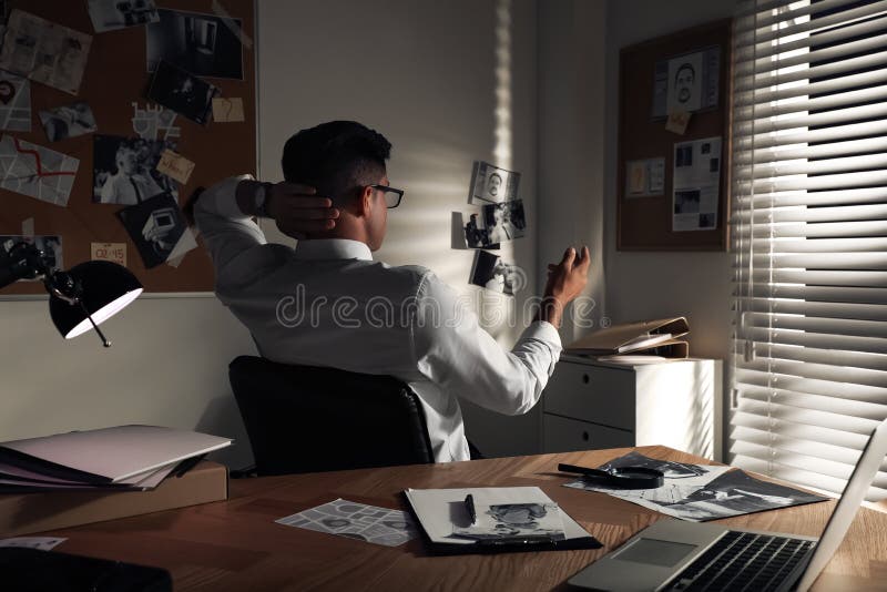 Detective Looking at Evidence Board in Office Stock Photo - Image of ...