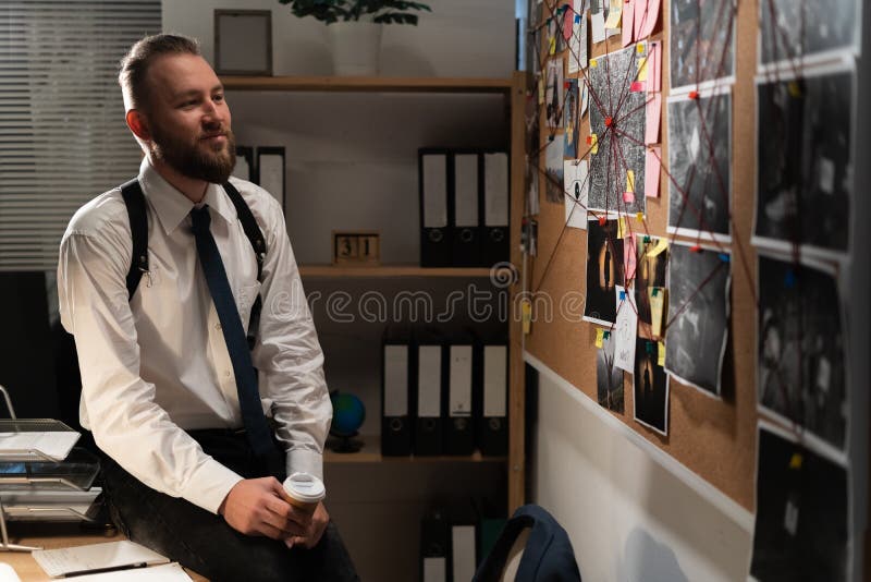 Detective Looking at Evidence Board with Photos in Office, Working at ...