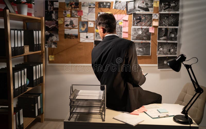 Detective Looking at Investigation Board in Office, Searching for ...