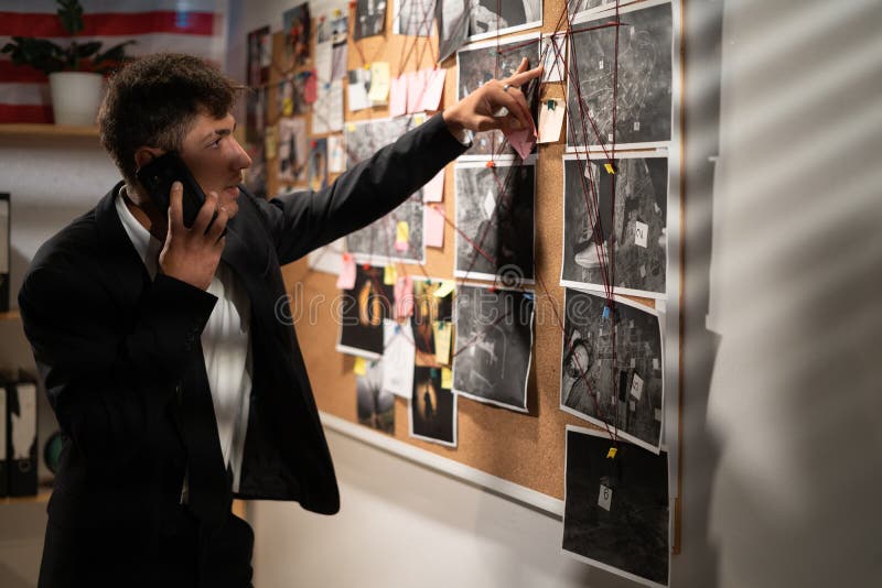 Detective Looking at Investigation Board in Office, Searching for ...
