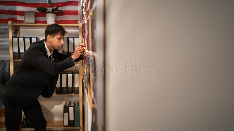 Detective Looking at Investigation Board, Searching for Solution ...