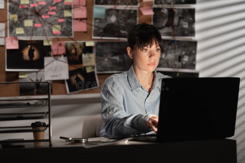 Detective Processing Evidence in Her Office Using a Laptop. Stock Photo ...