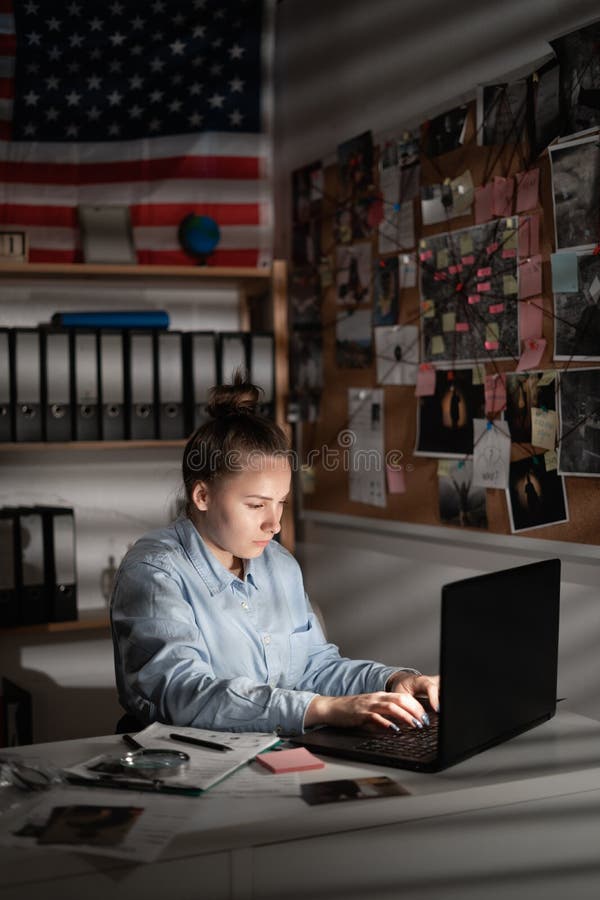 Detective Processing Evidence in Office Using Laptop Computer at Night ...